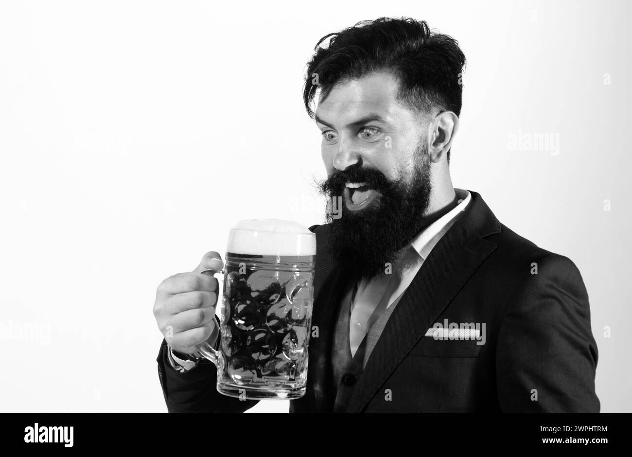 Funny excited man in classical suit holding glass with beer in hand ...