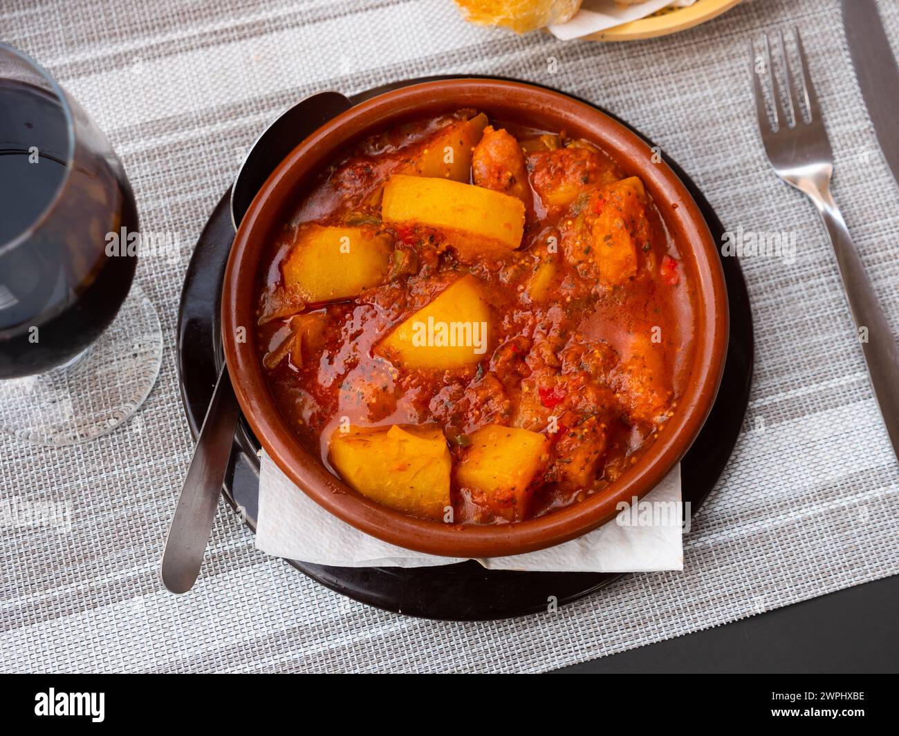 Traditional Spanish dish of potatoes simmered with chorizo, pancetta ...