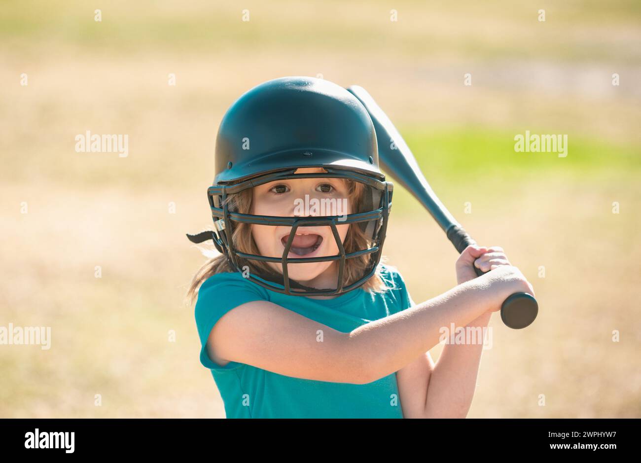 Excited kid holding a baseball bat. Pitcher child about to throw in ...