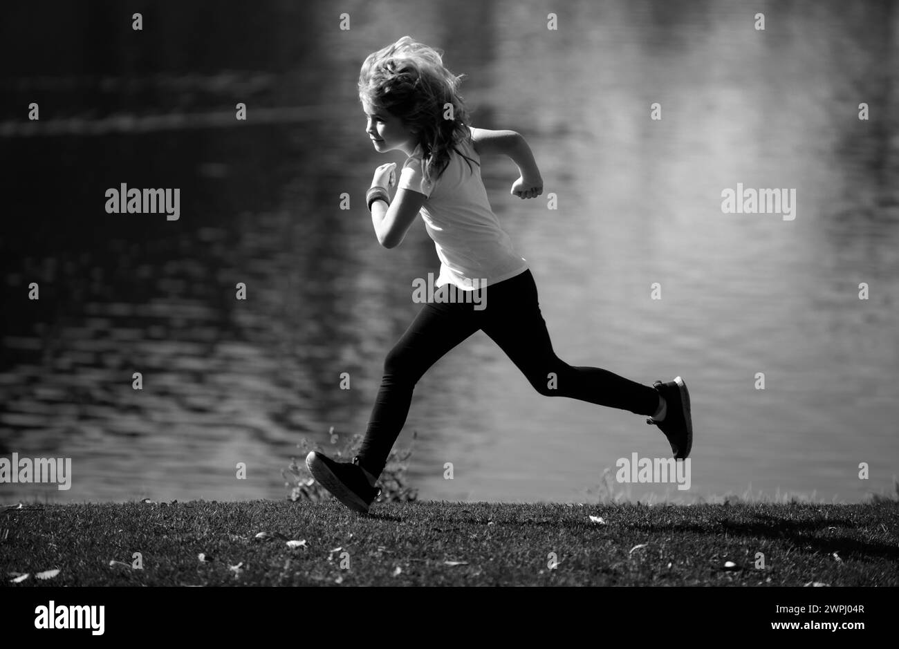 Child boy running outdoors. Kid running in a summer park. Morning ...