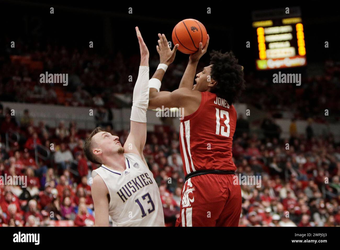 Washington State forward Isaac Jones, right, shoots while pressured by ...