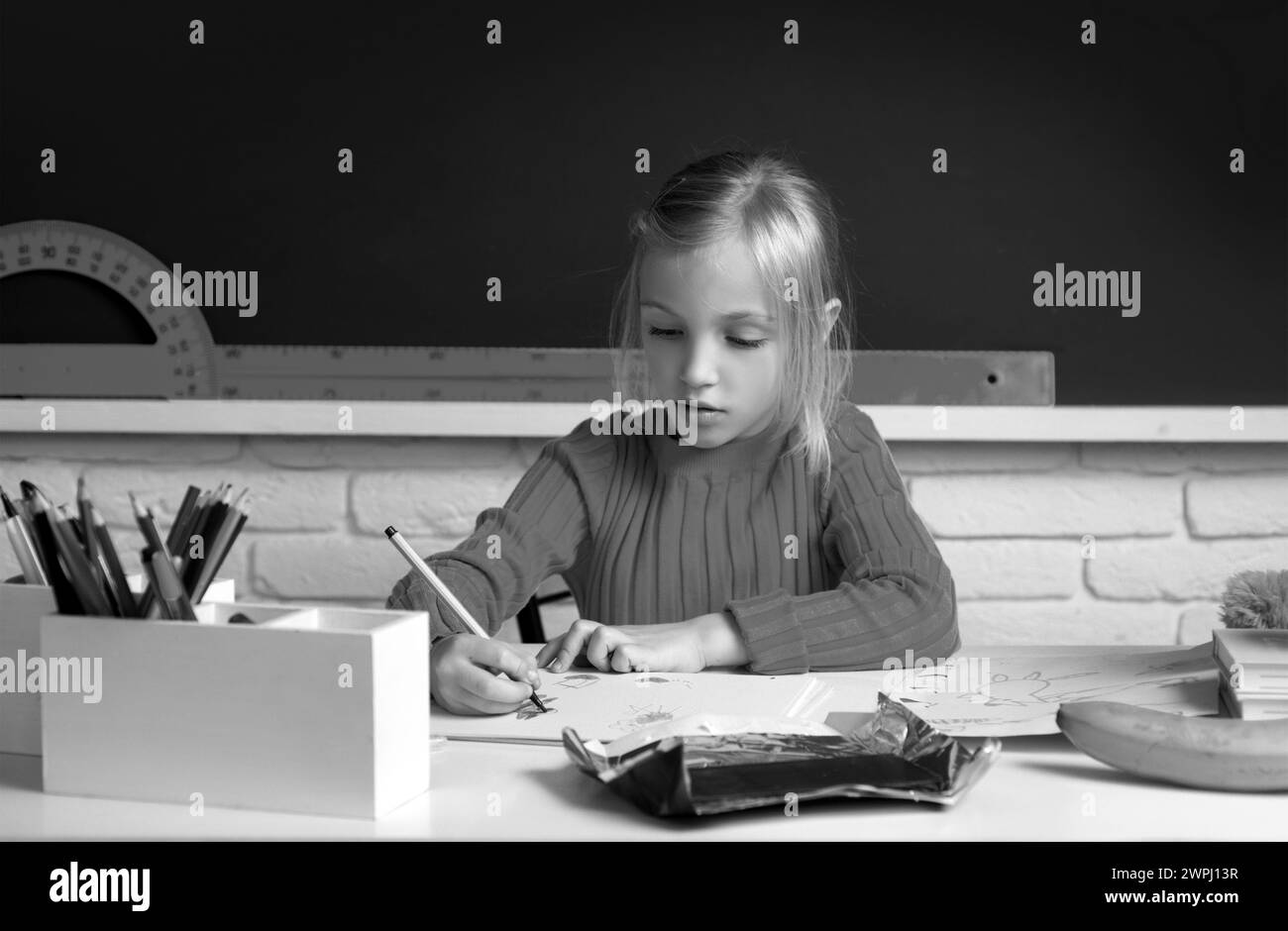 Kid girl learning lesson at school. Elementary school child in class ...