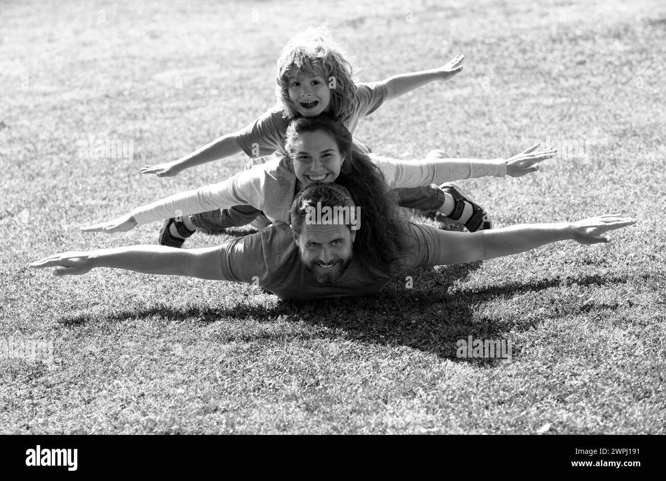 Young family with child having fun in nature. Fly concept, little boy ...