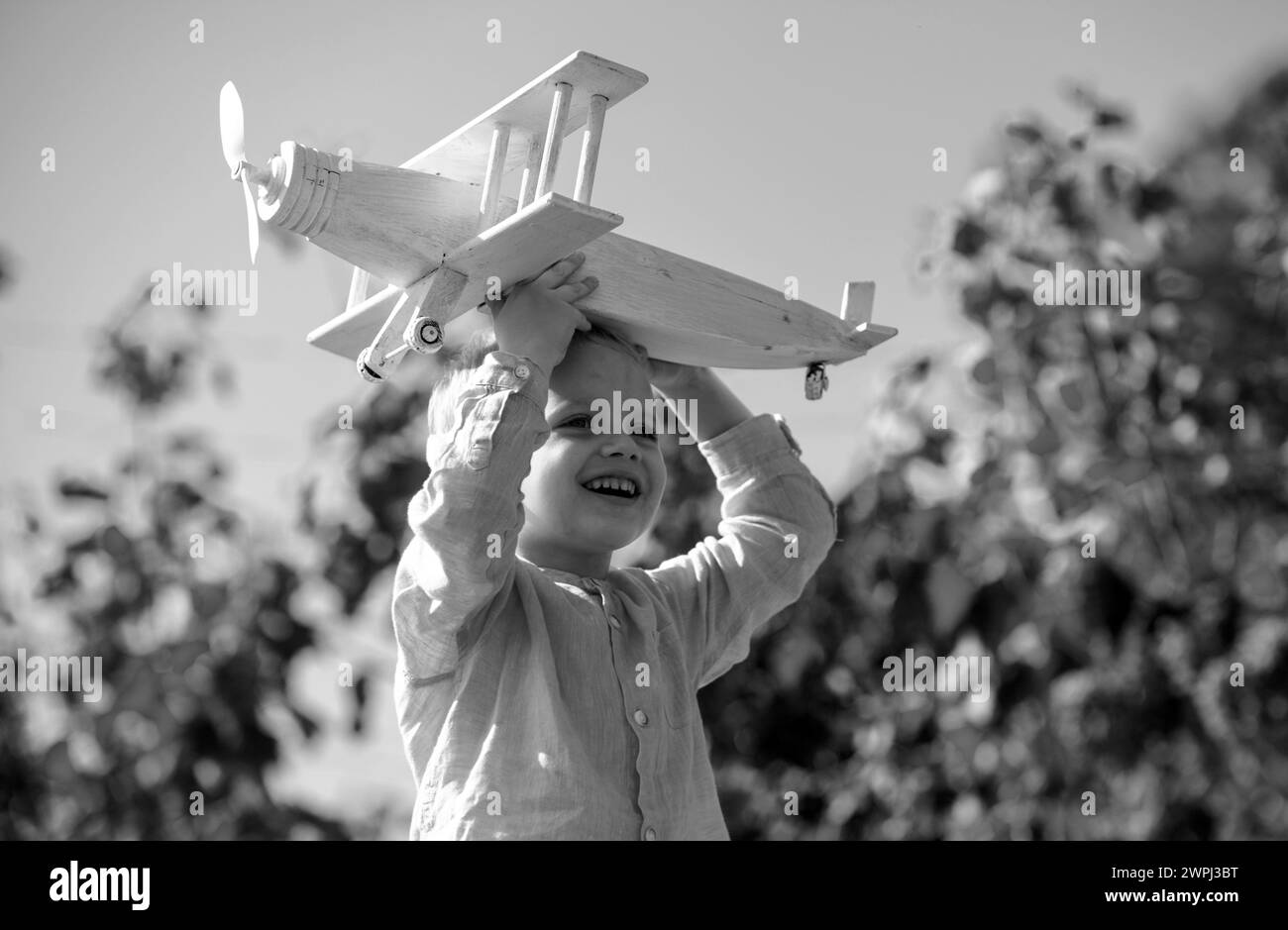 Dreams of flight. Child playing with toy plane against the sky. Dreams ...