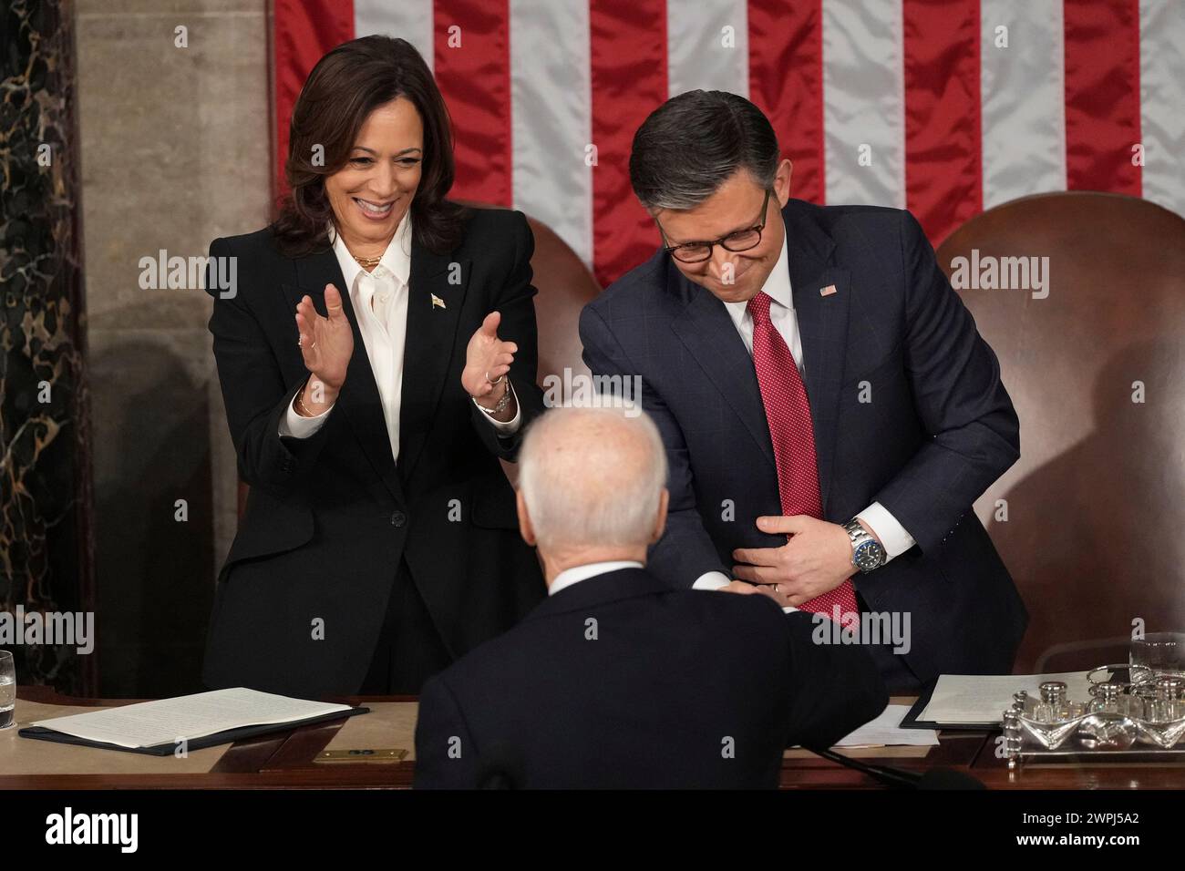 President Joe Biden shakes hands with House Speaker Mike Johnson of La ...