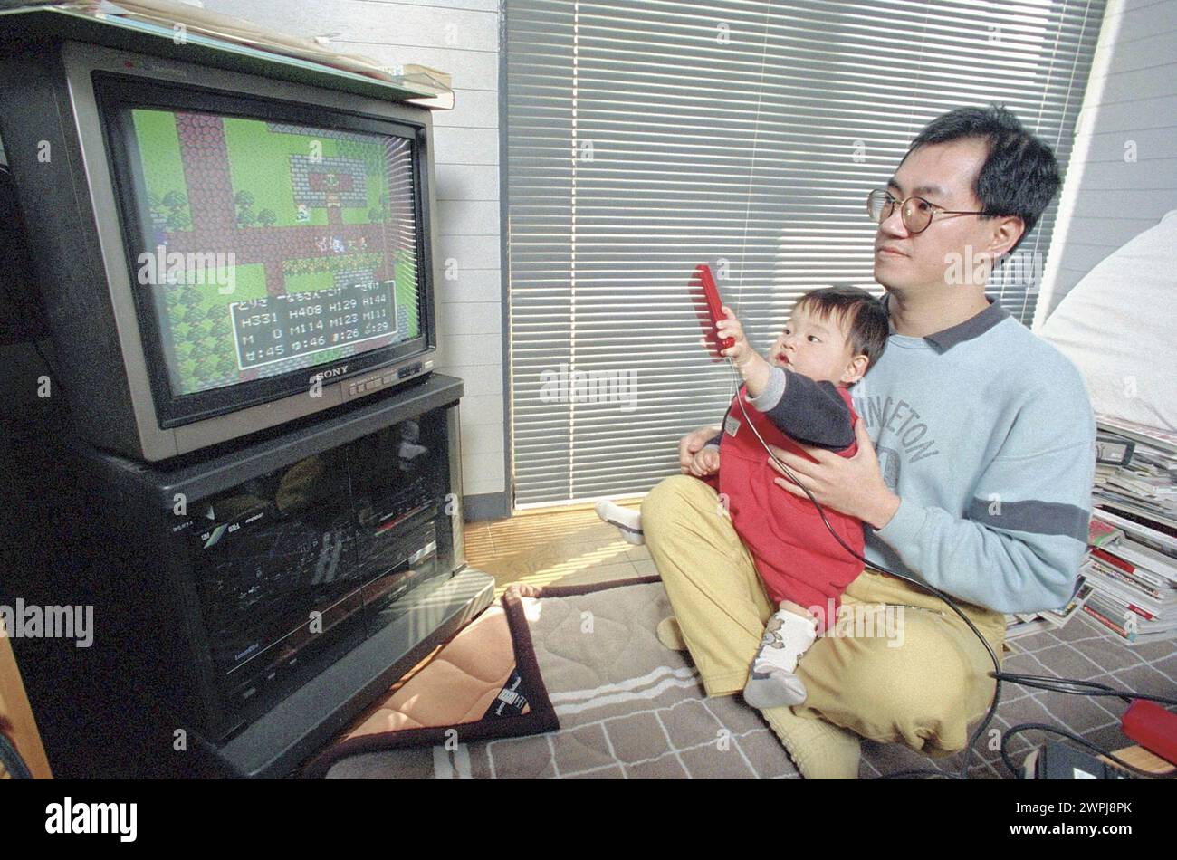 A file photo shows Japanese manga artist Akira Toriyama plays a game ...