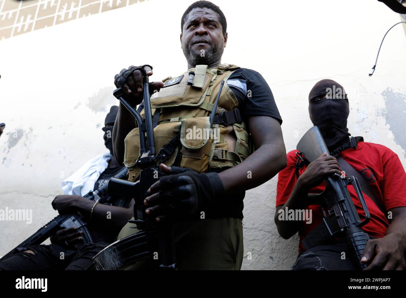 Barbecue, the leader of the "G9 and Family" gang, stands with his ...