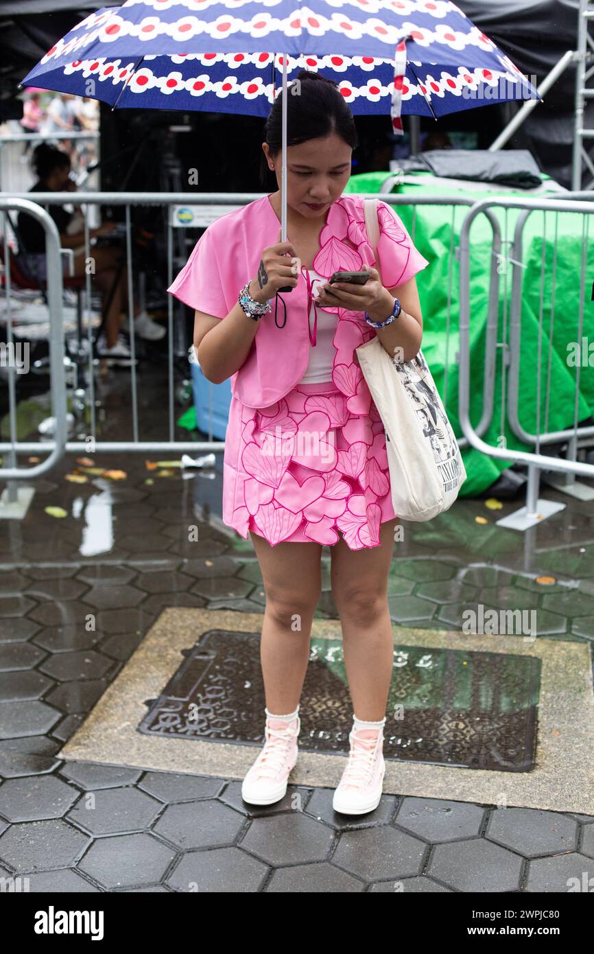 7 March 2024. A female fan dress in all pink holding an umbrella at ...