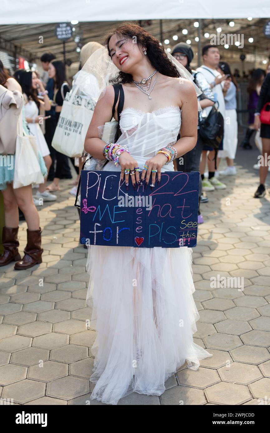7 March 2024. A female fan dress in white gown at Taylor Swift The Eras ...