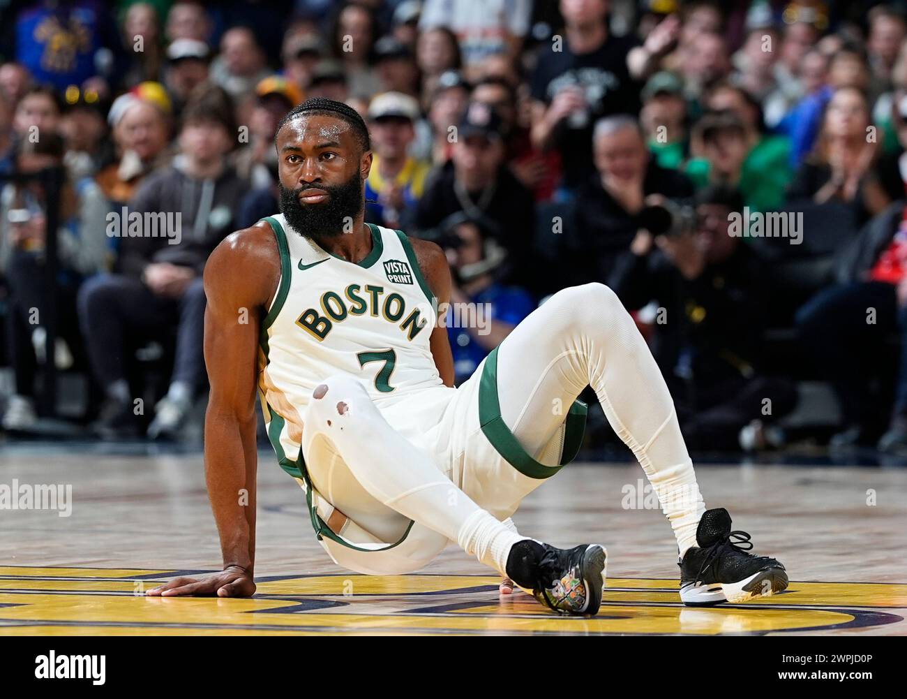 Boston Celtics guard Jaylen Brown gets up from the floor after falling ...