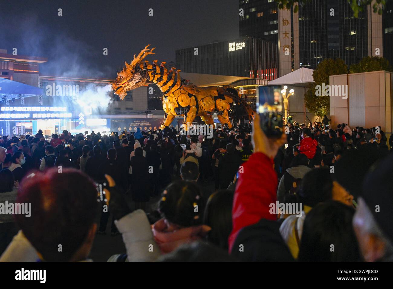 People watch the farewell performance of a large mechanical ...