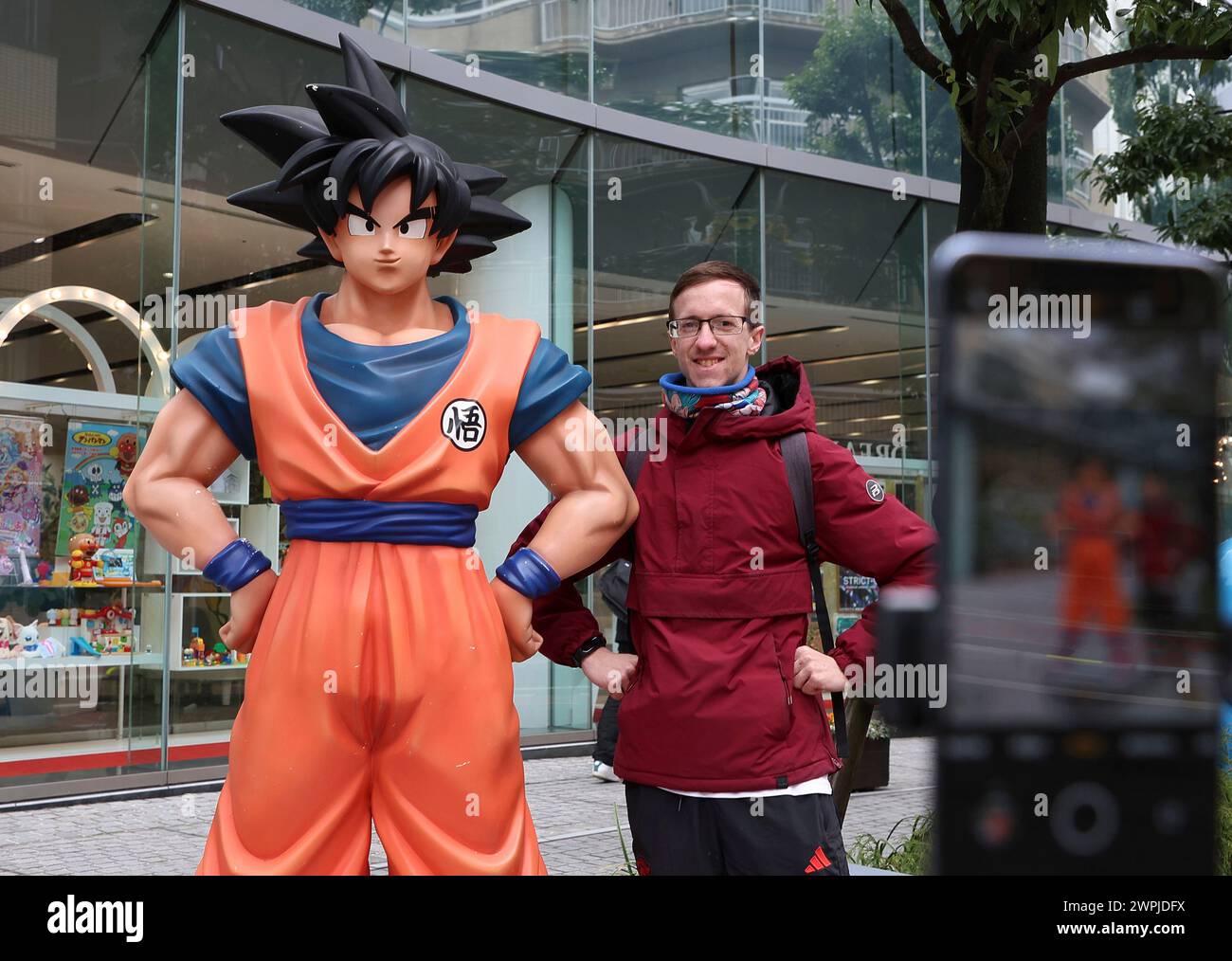 People take a photo with a statue of Son Goku, a protagonist of Dragon ...