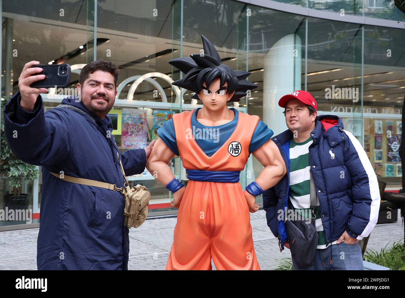 People take a photo with a statue of Son Goku, a protagonist of Dragon ...
