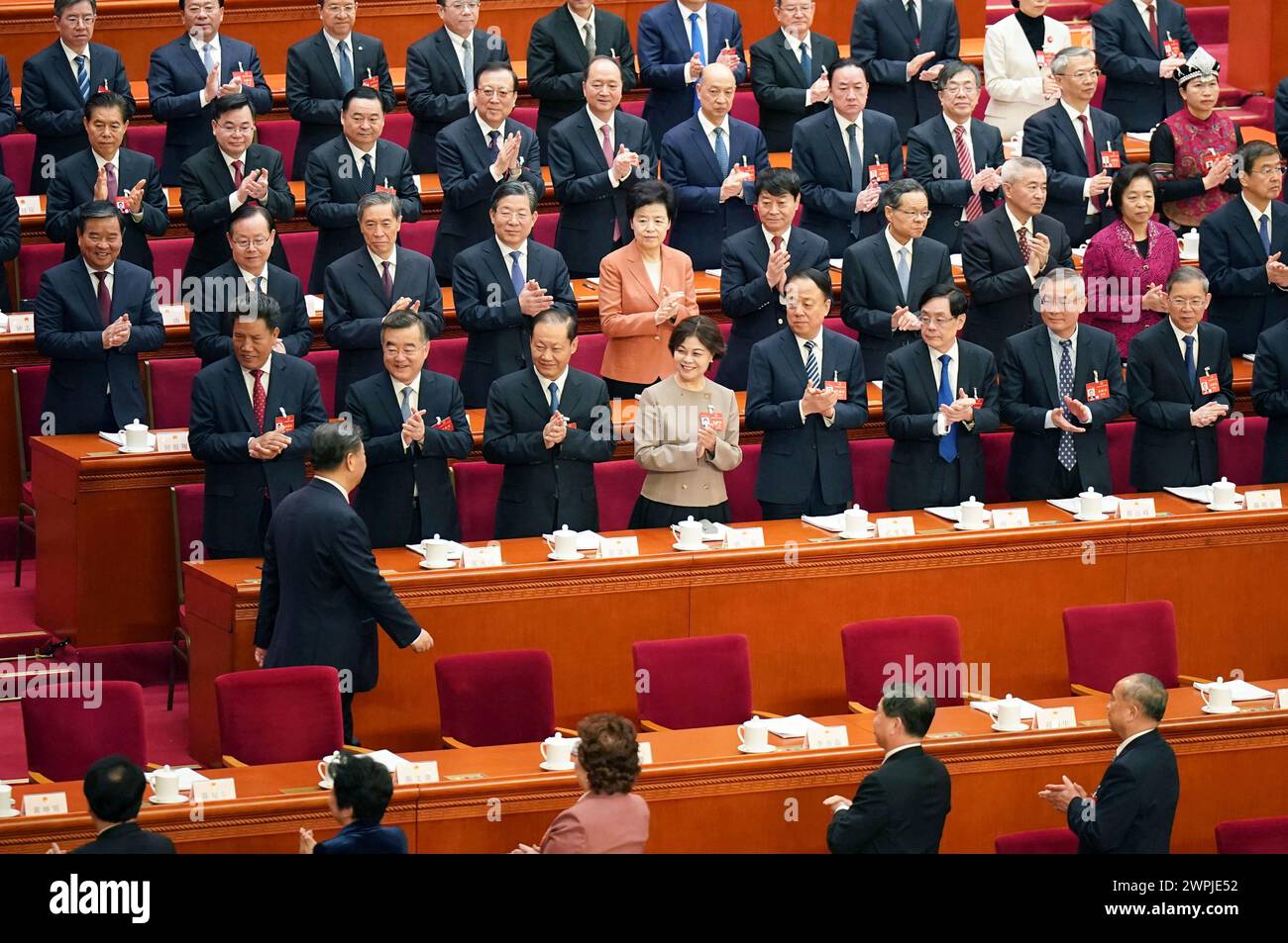 Chinese President Xi Jinping is greeted with applause by the delegates ...