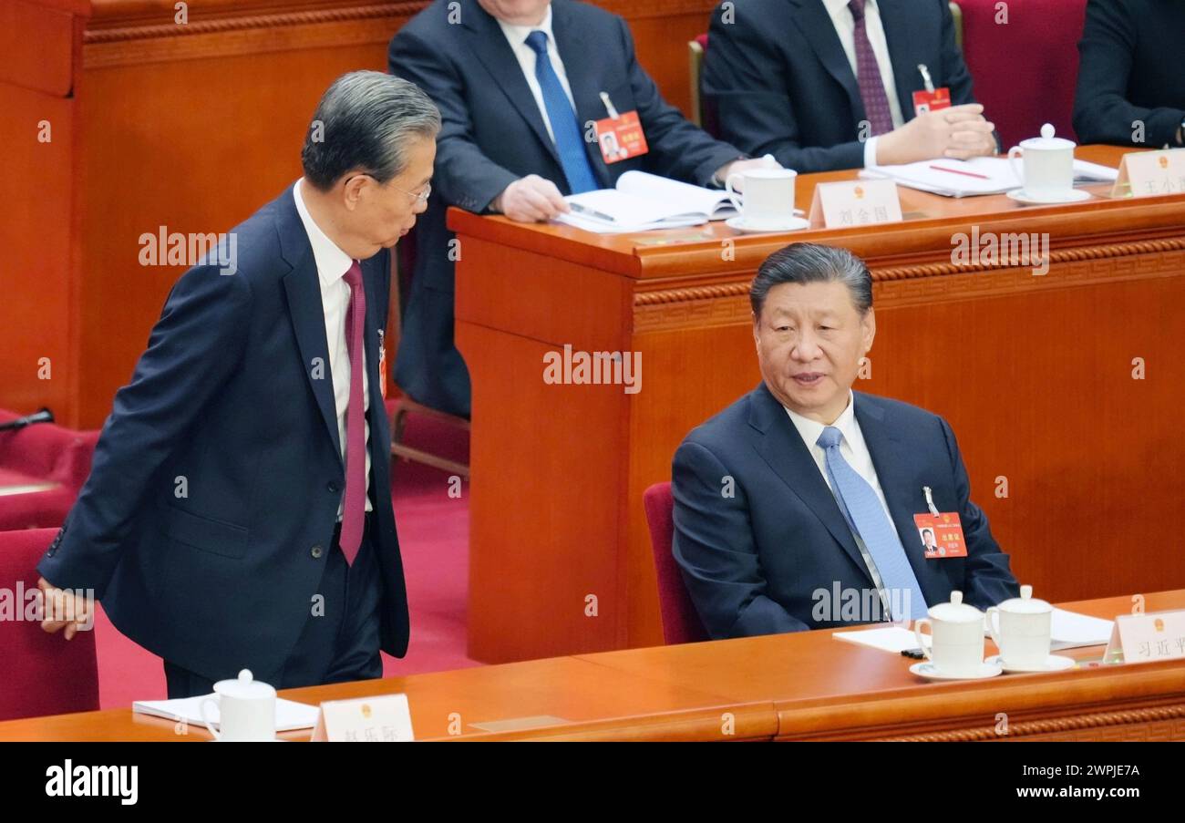 Chinese President Xi Jinping (R) talks with Zhao Leji during a plenary ...