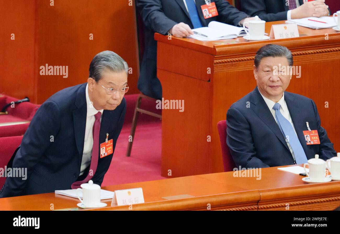 Chinese President Xi Jinping (R) and Zhao Leji attend a plenary session ...