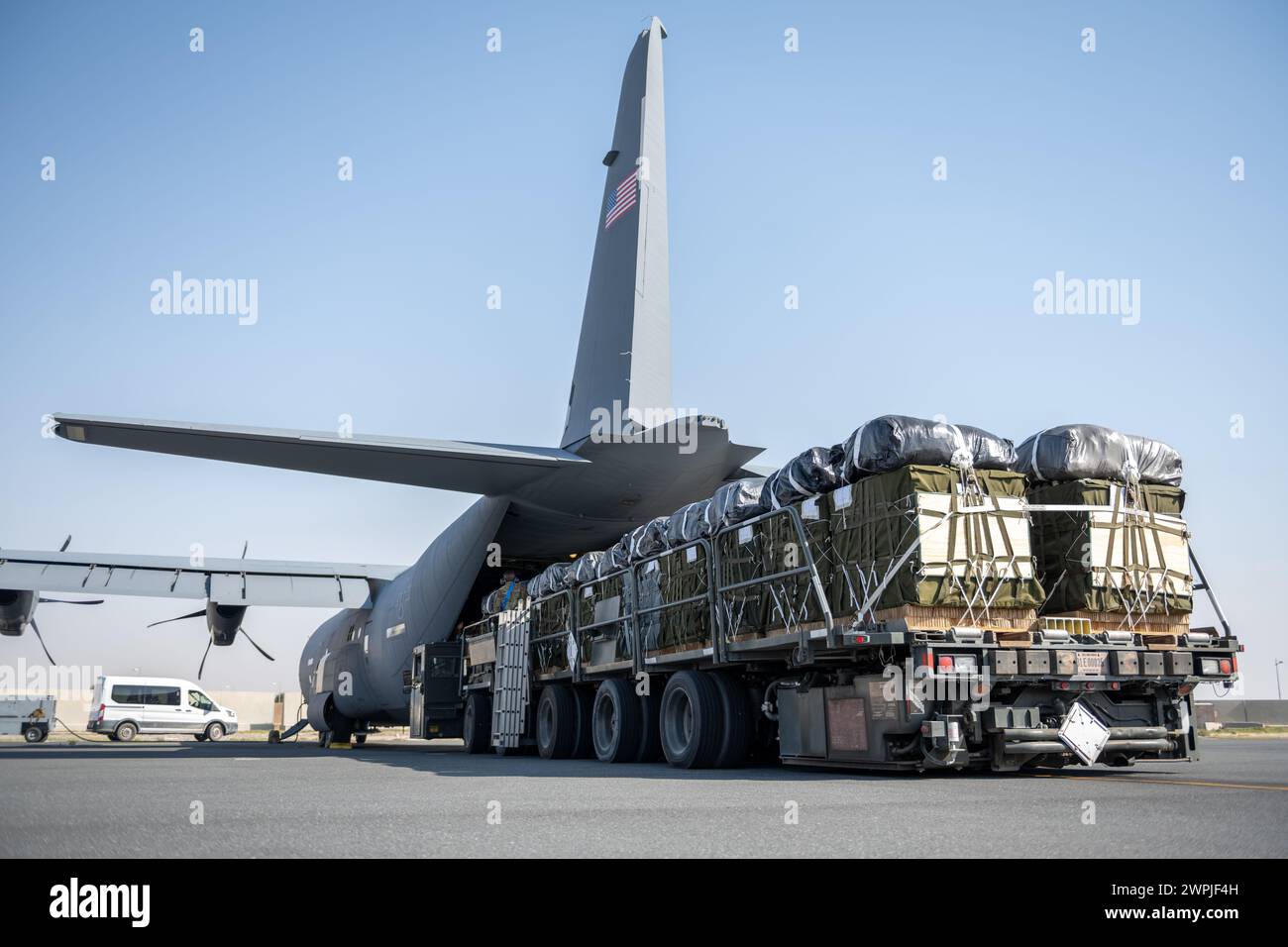 A U.S. Air Force K-loader filled with pallets of Halal meals destined ...