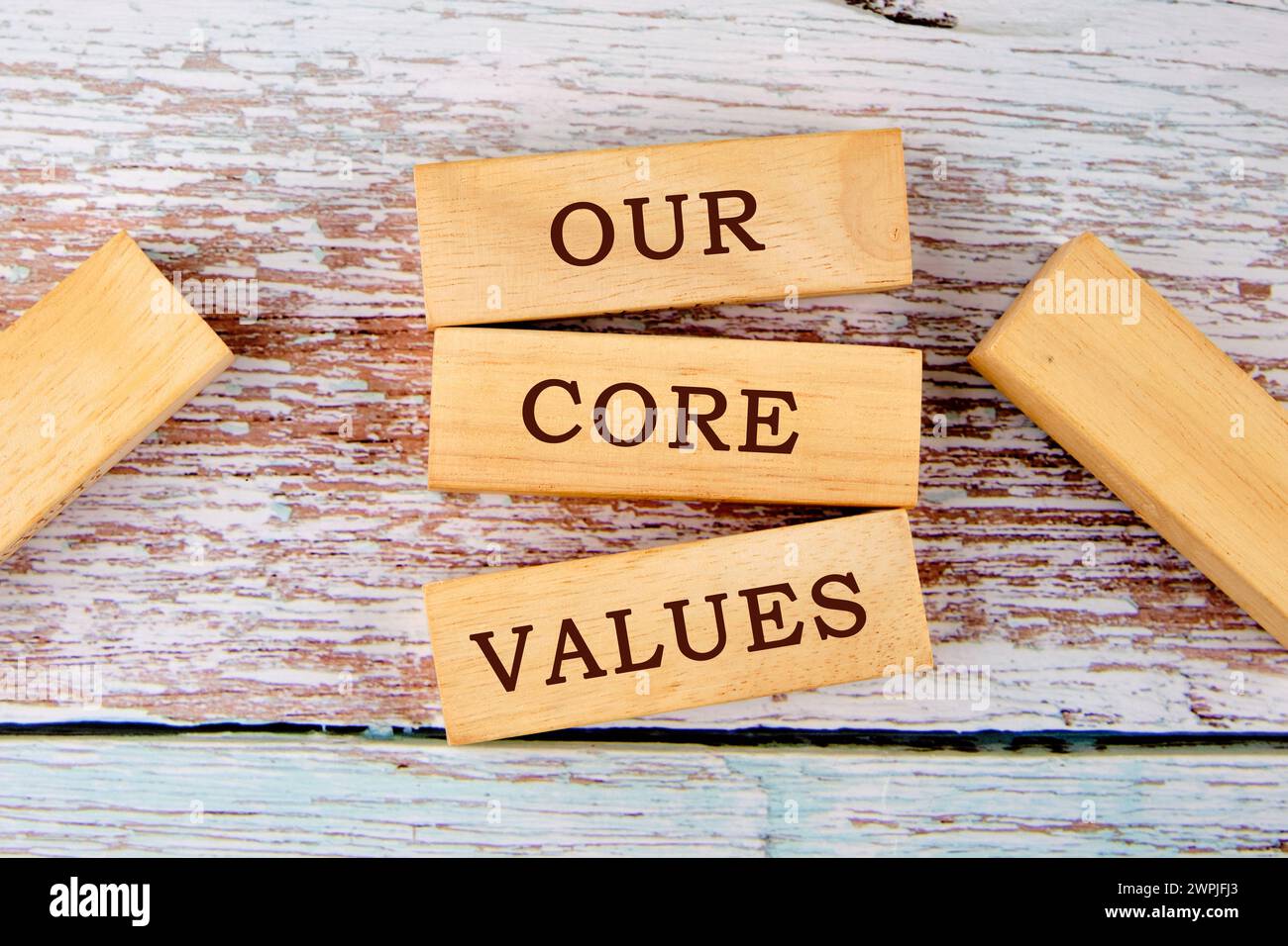 Concept words OUR CORE VALUES symbol on wooden blocks on old boards ...