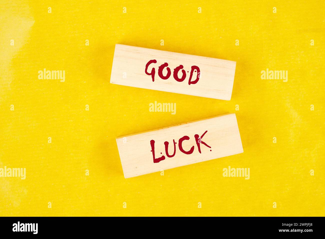 GOOD LUCK symbol on wooden blocks on a yellow background Stock Photo ...
