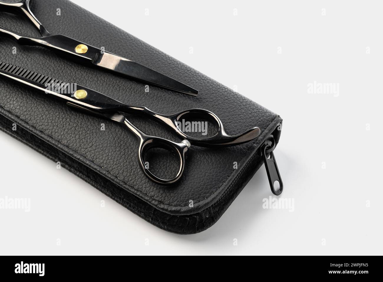 Hairdressing scissors with leather case on white background Stock Photo ...