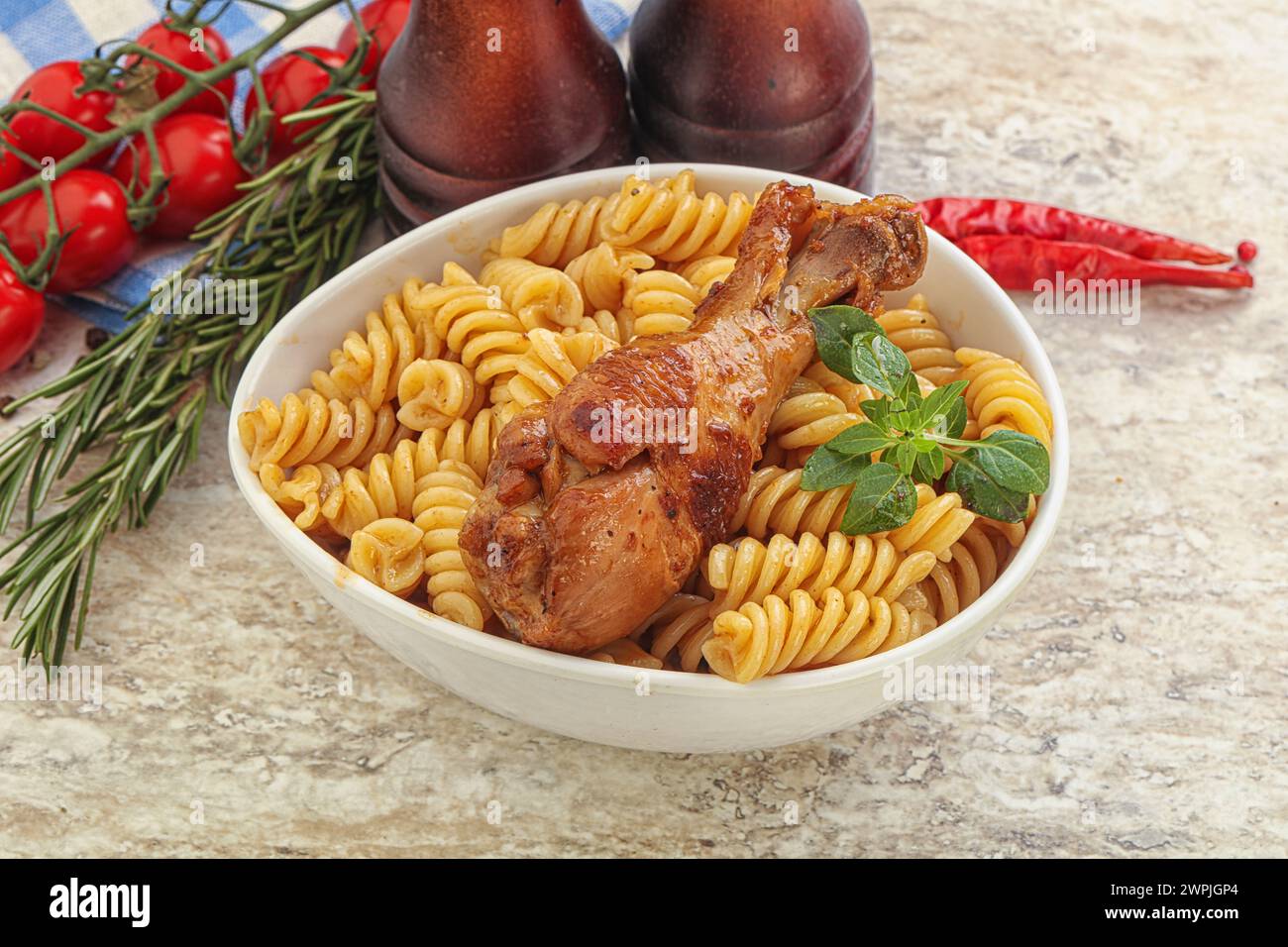 Roasted chicken leg with macaroni pasta Stock Photo - Alamy