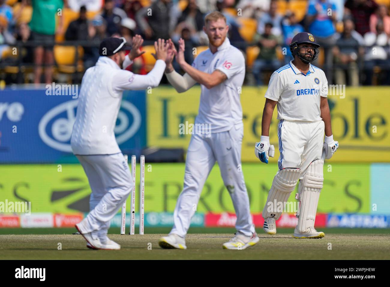 India's captain Rohit Sharma, right, is bowled out by England's captain ...