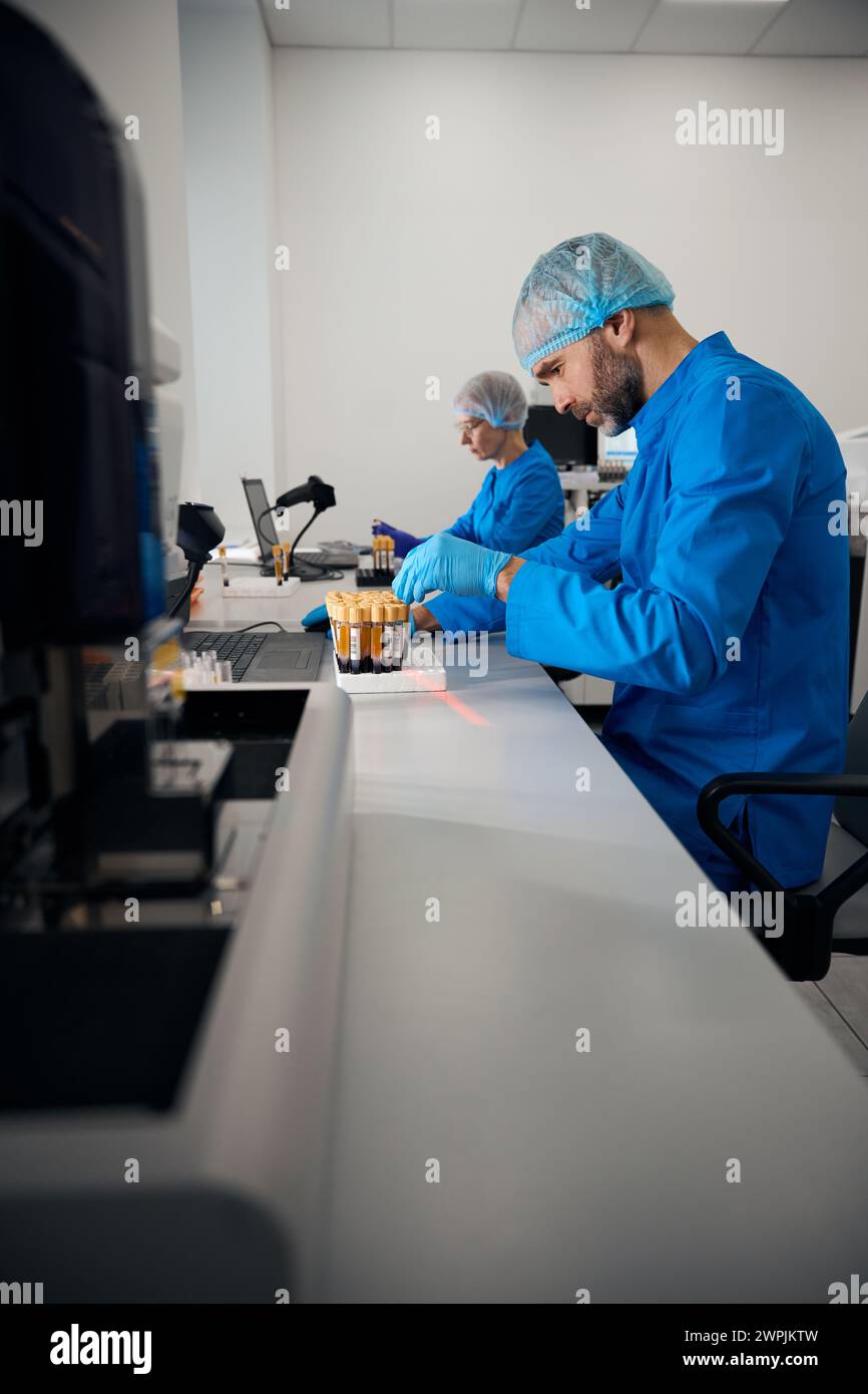 Male laboratory assistant works with blood samples Stock Photo - Alamy