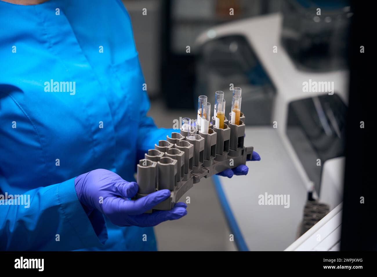 Specialist with test tubes with biomaterial for analysis in his hands ...