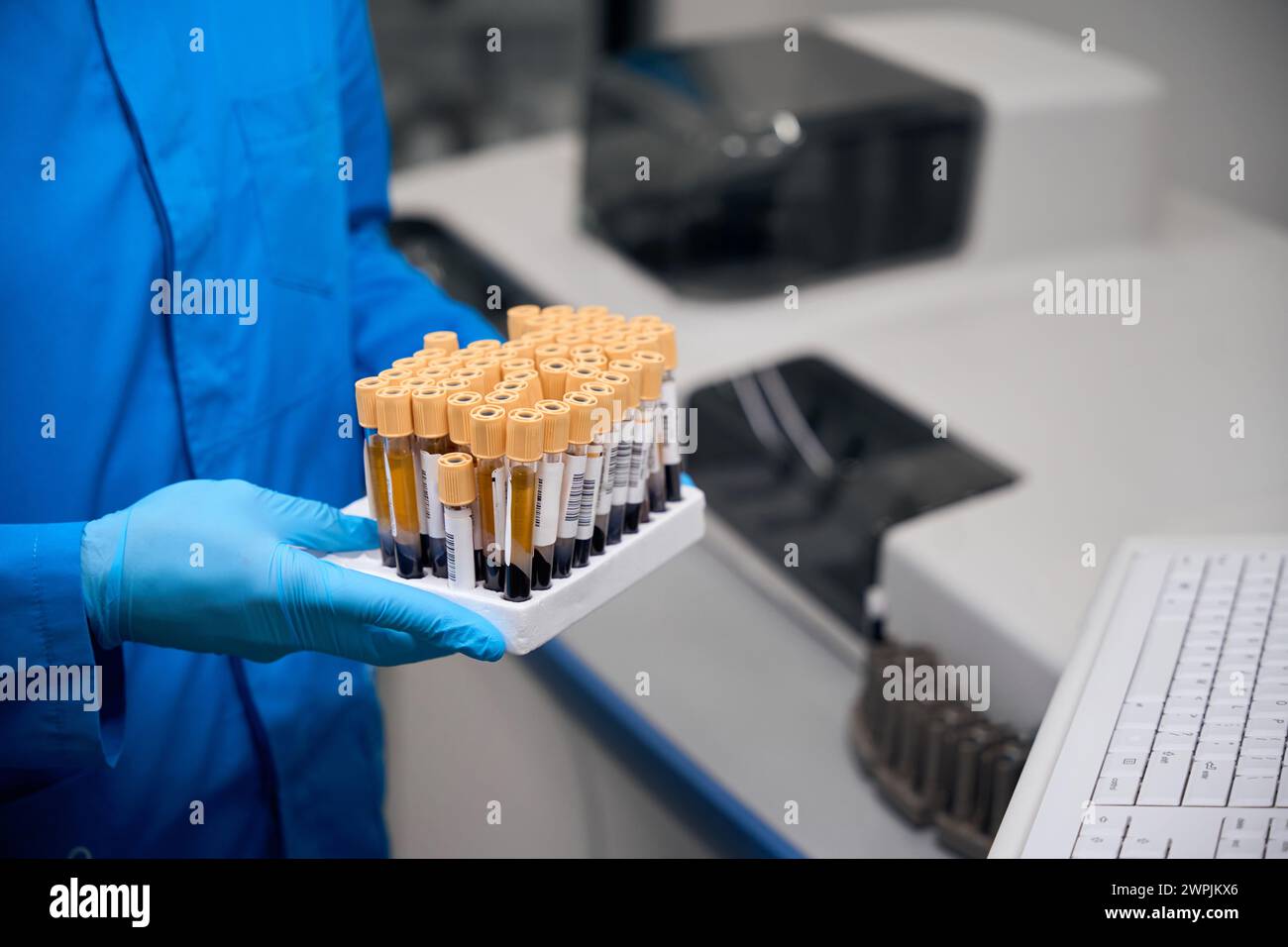 Laboratory assistant holds test tubes hi-res stock photography and ...