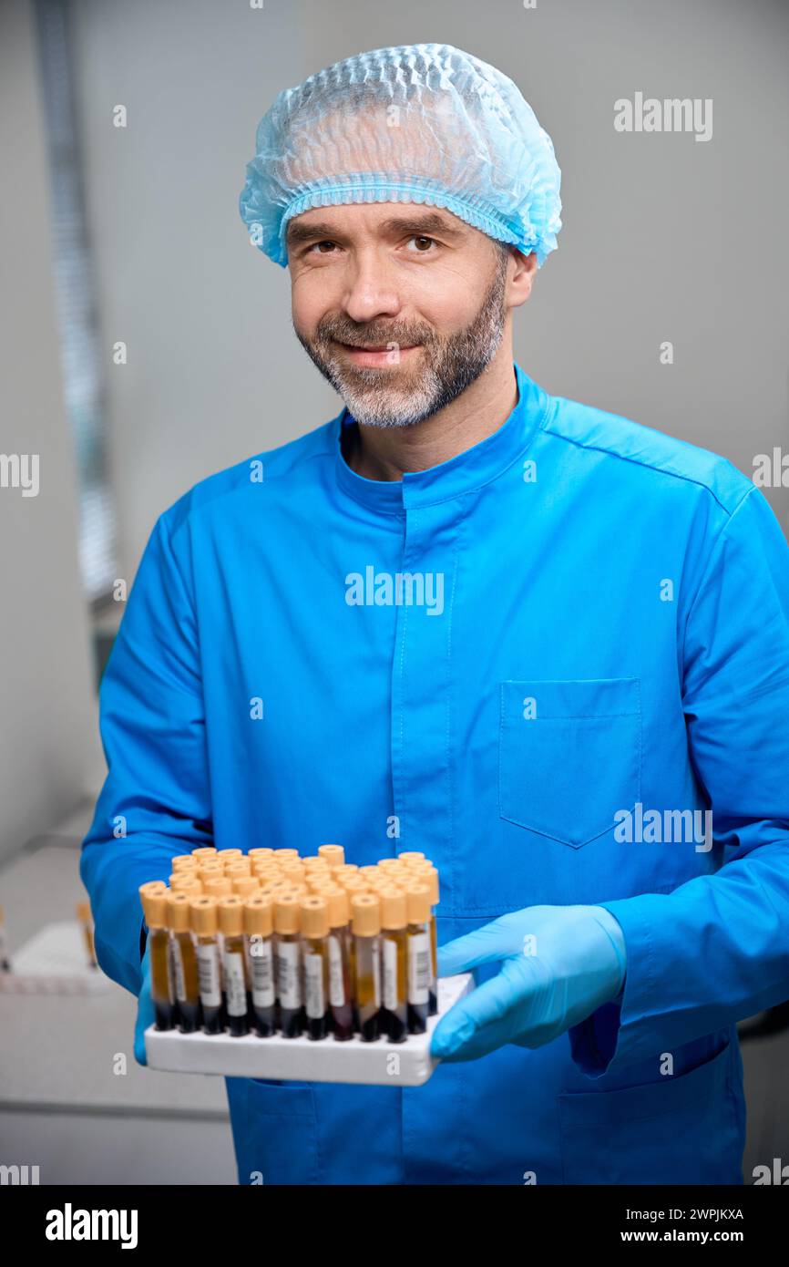 Laboratory worker holds set with biomaterial for blood analysis in his ...