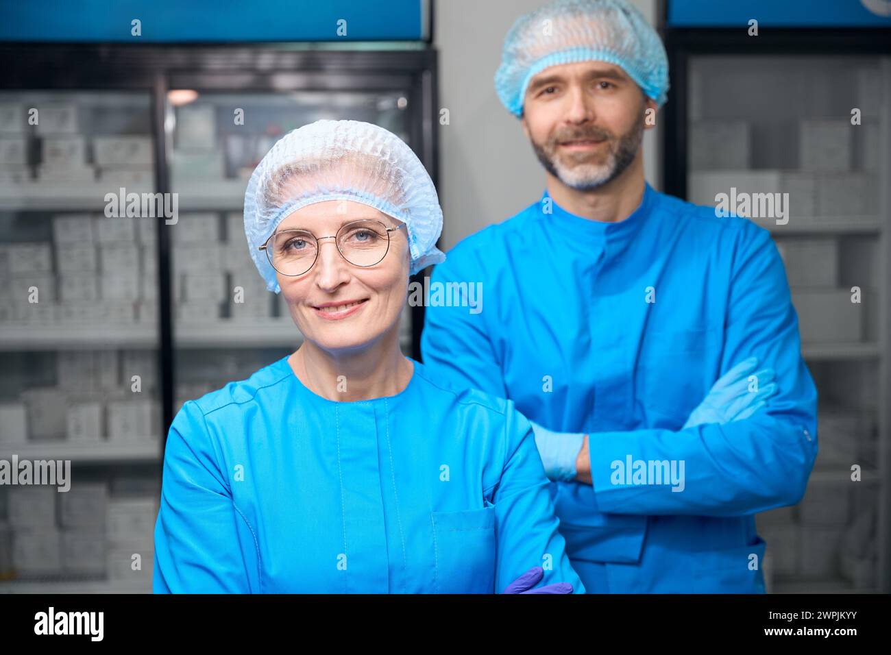 Laboratory assistants in blue uniforms stand in the laboratory Stock ...