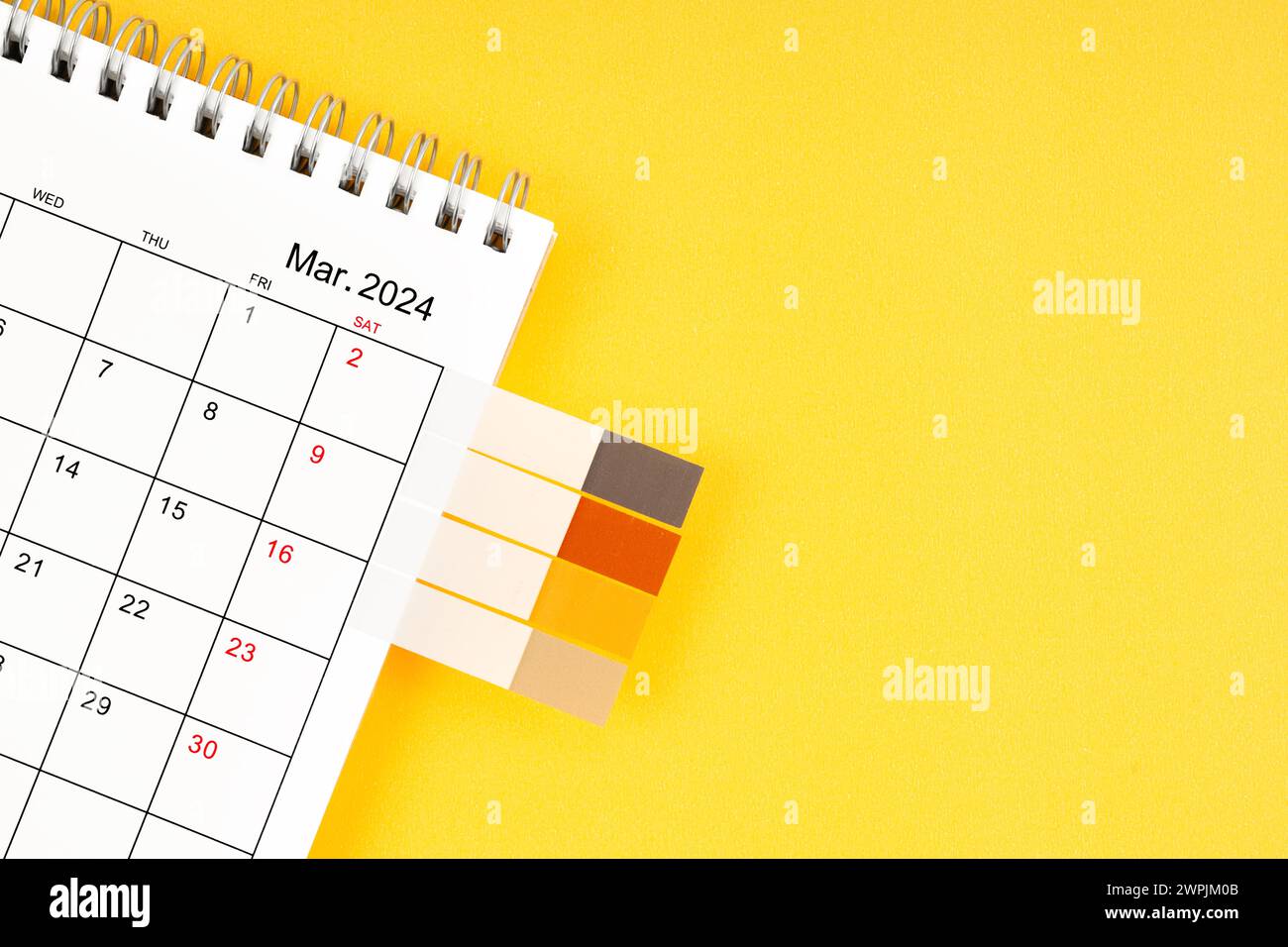 March 2024 Monthly desk calendar and blank adhesive note on yellow ...