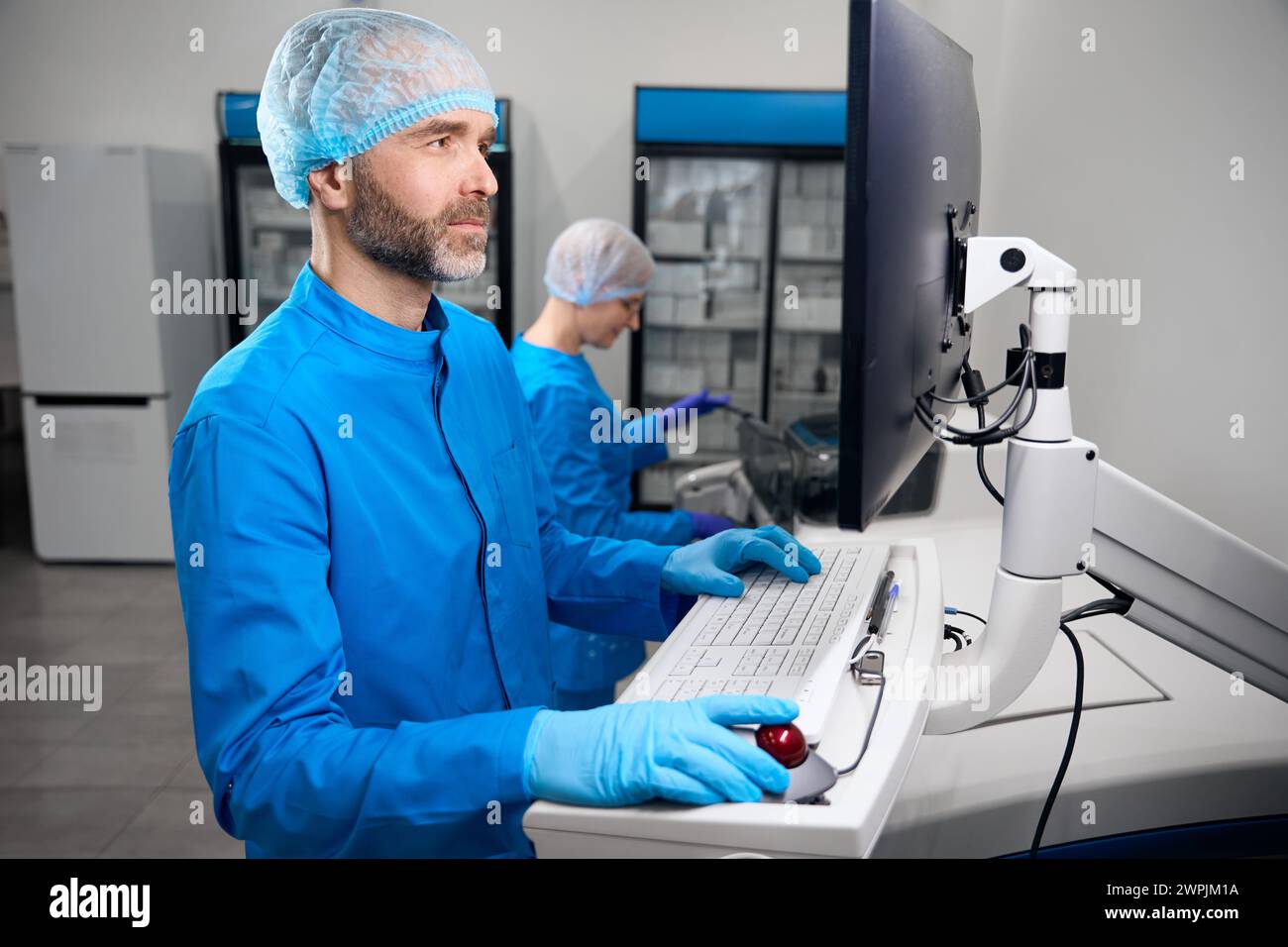 Male virologist and his colleague use a special apparatus Stock Photo ...