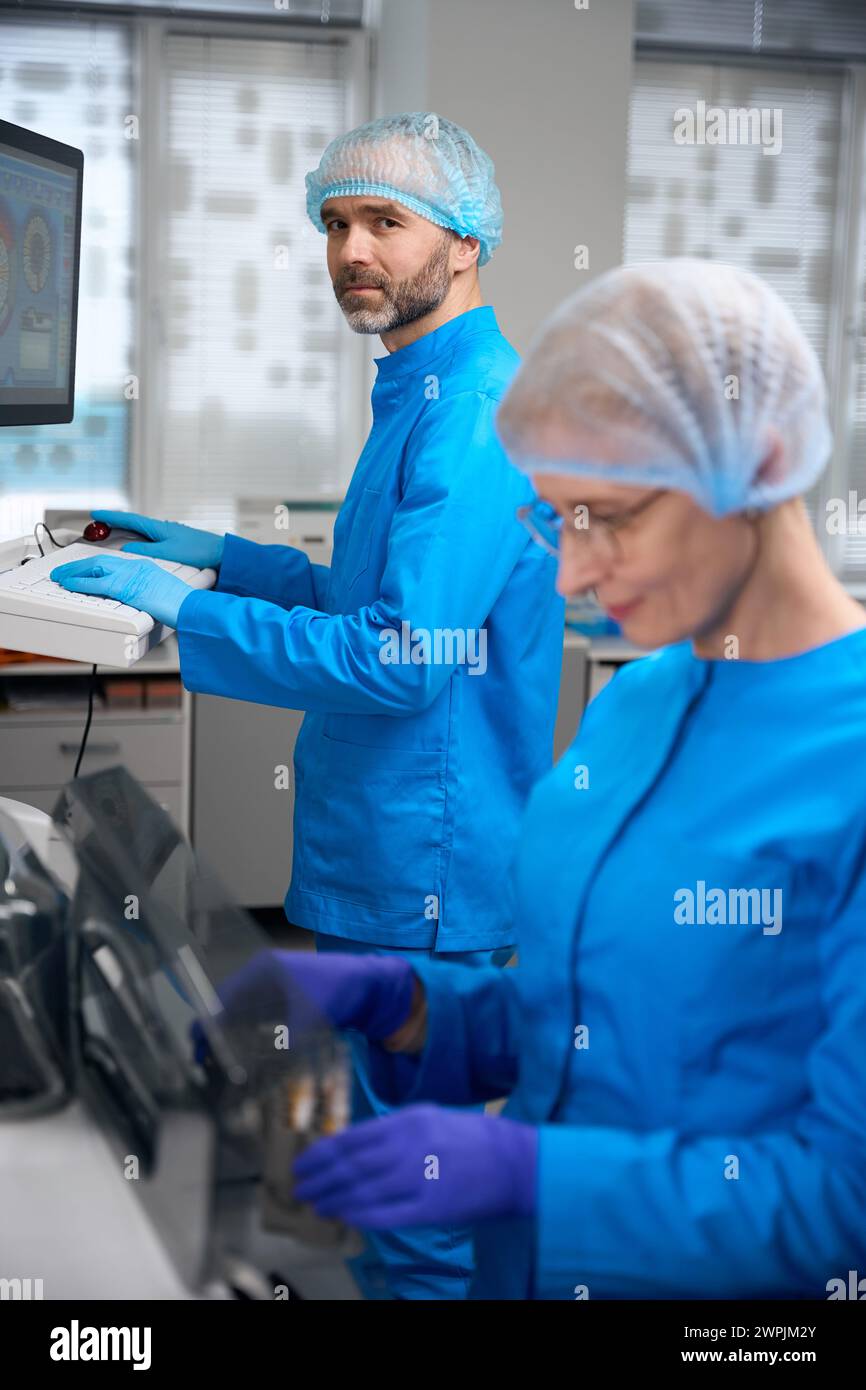 Laboratory employees use high-tech equipment in their work Stock Photo ...