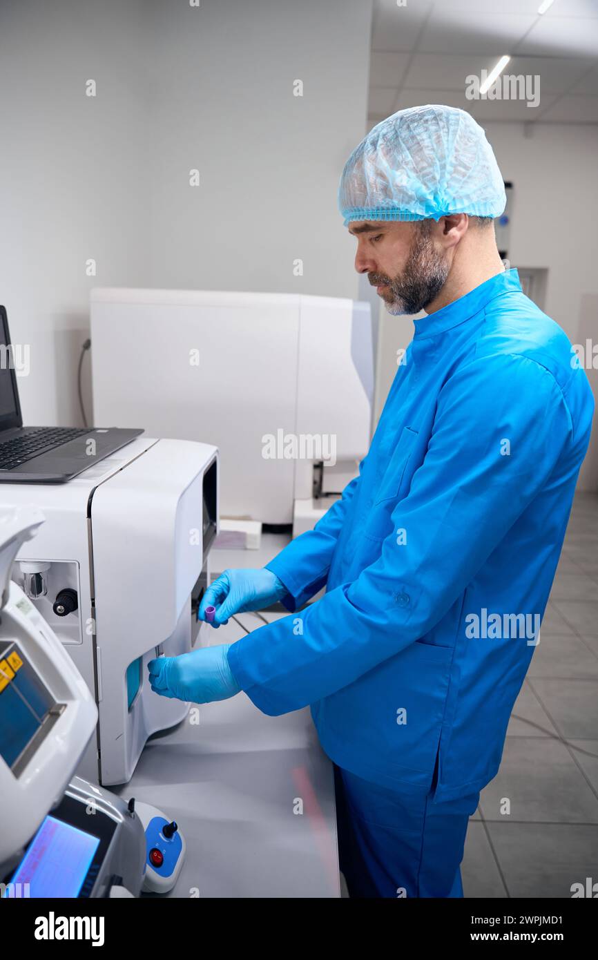Specialist works on apparatus for automatic extraction of nucleic acids ...