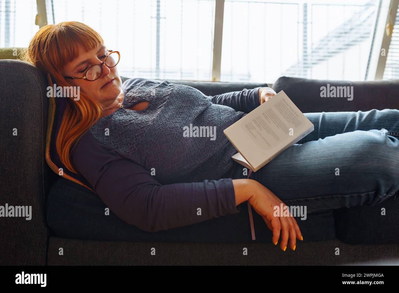 portrait tired middle-aged woman falling asleep while reading book ...