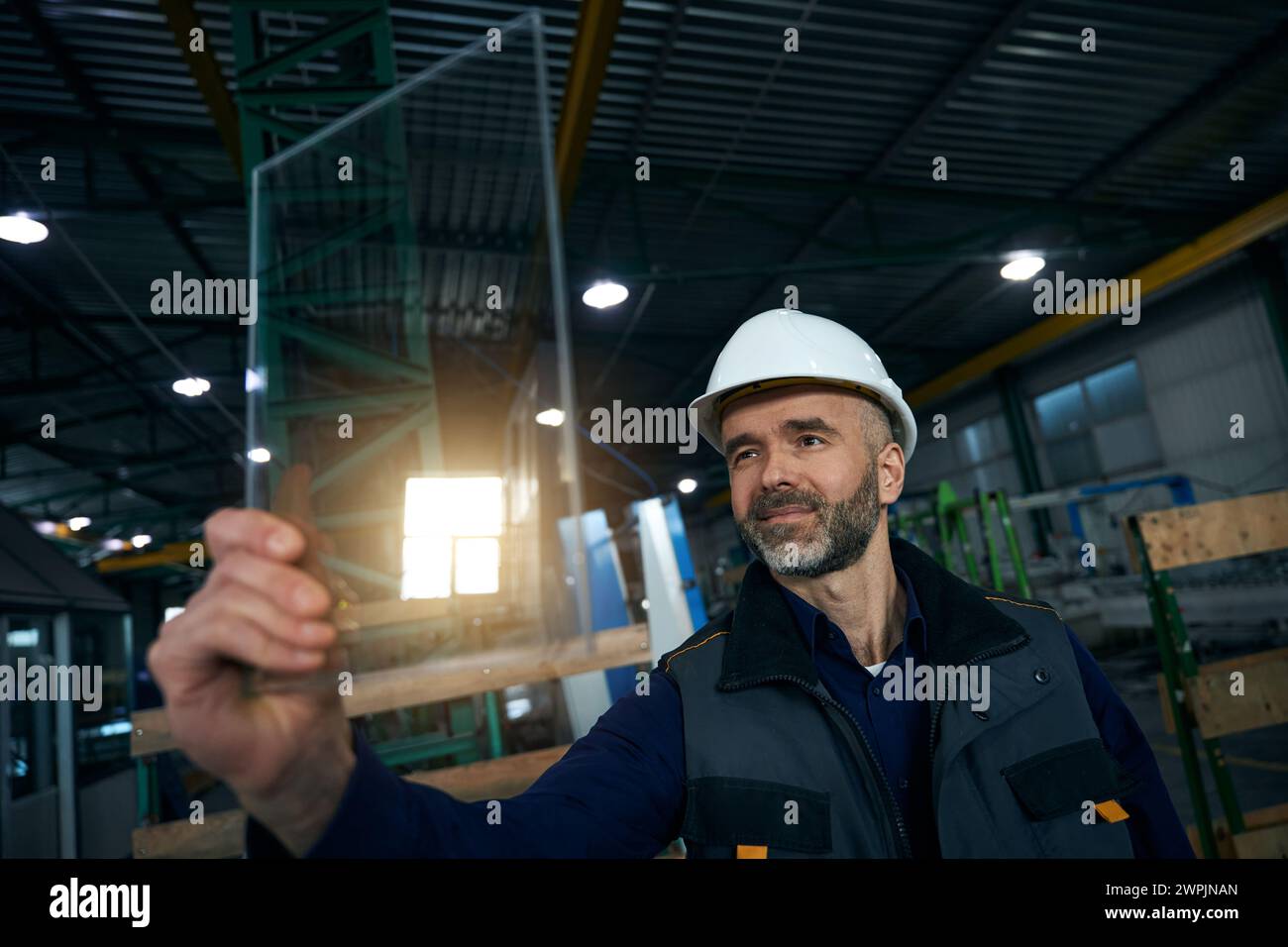 Master in protective helmet holds in his hands material for double ...