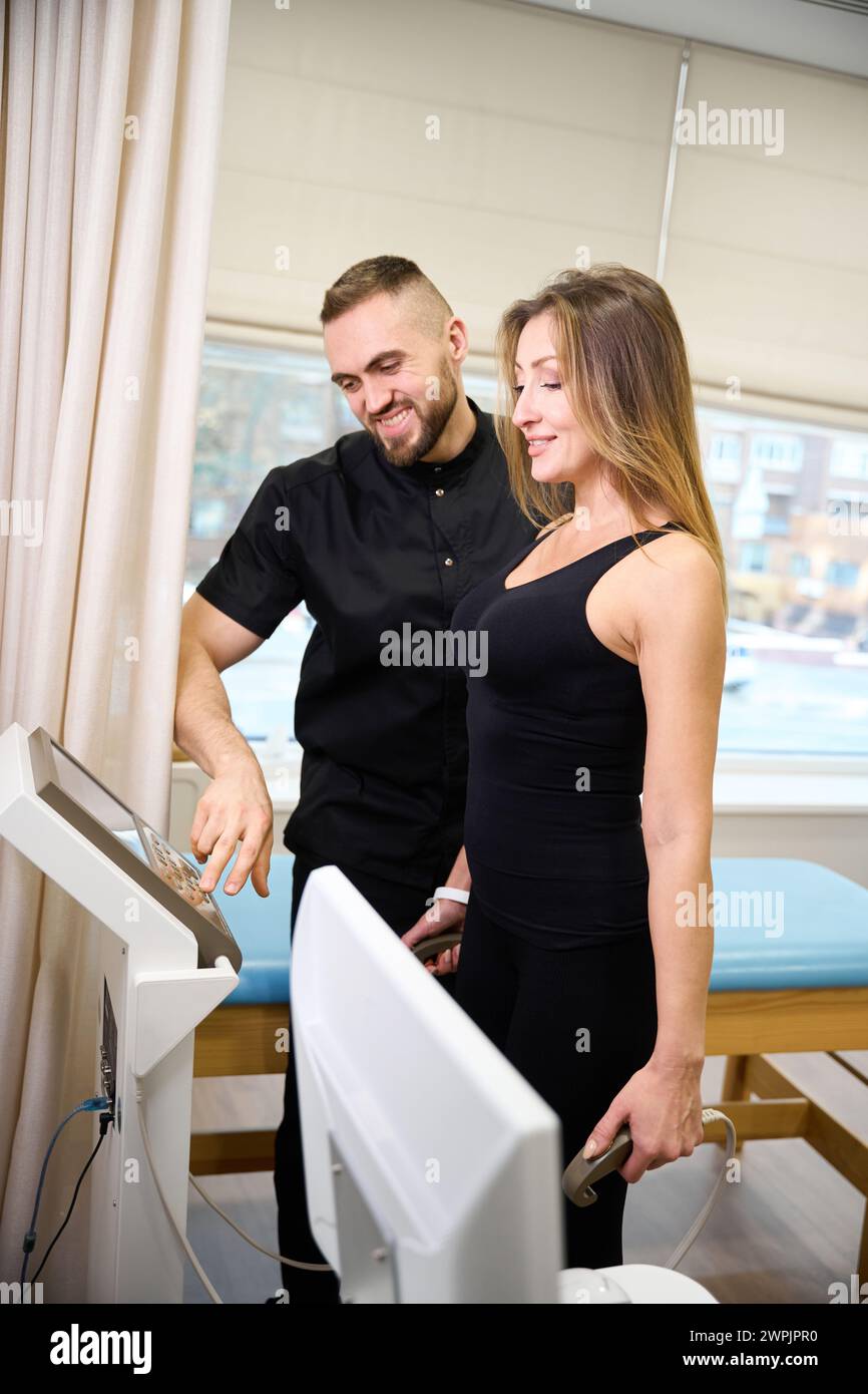 Doctor adjusting special equipment hi-res stock photography and images ...