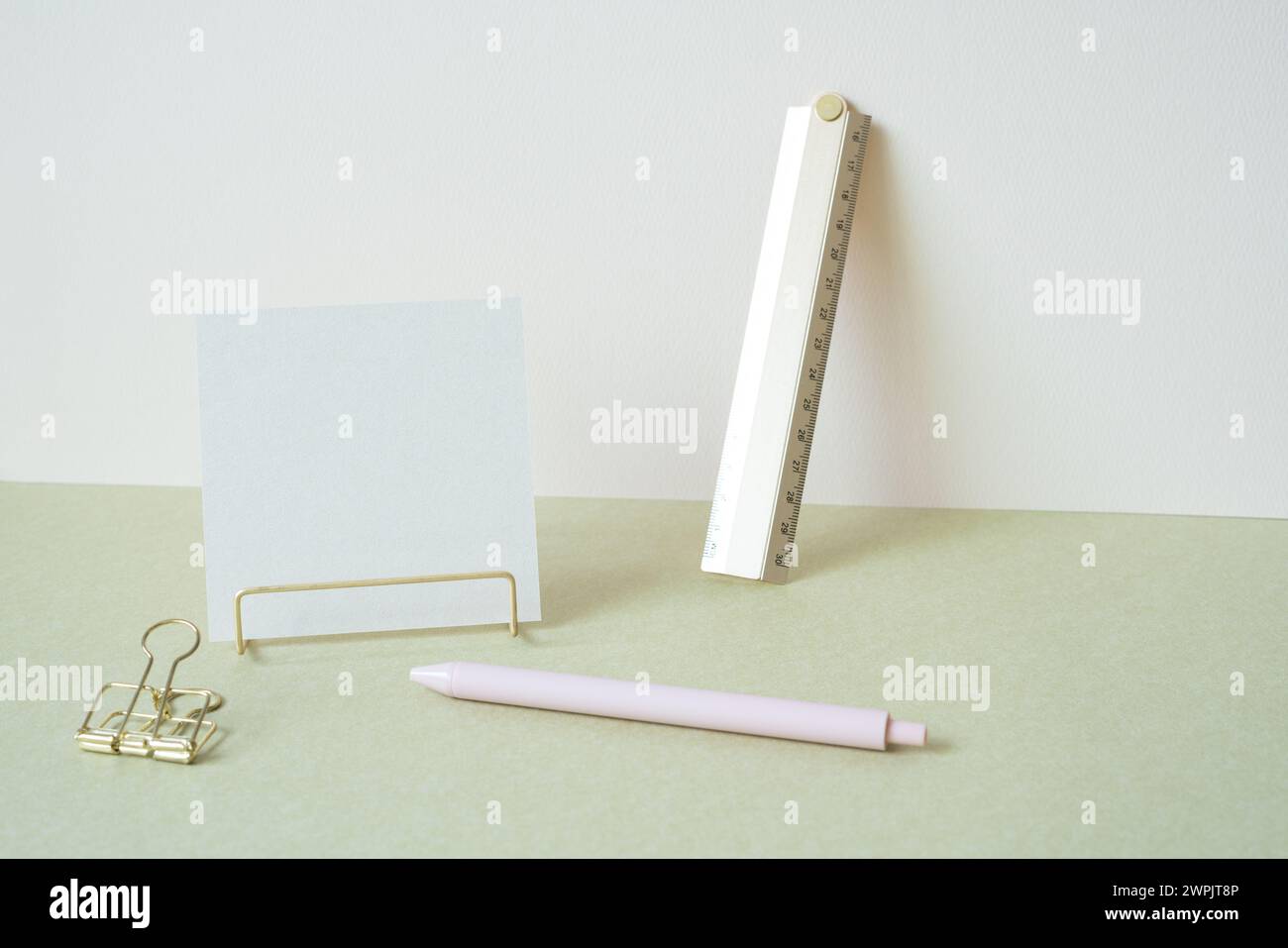 Blank memopad with gold metallic holder, ruler, pen, clip on desk ...