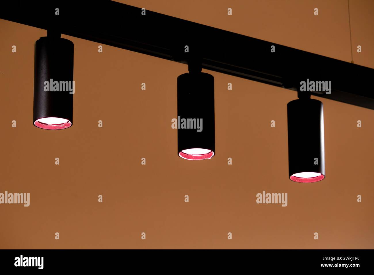 Three lamps and orange wall abstract background Stock Photo - Alamy