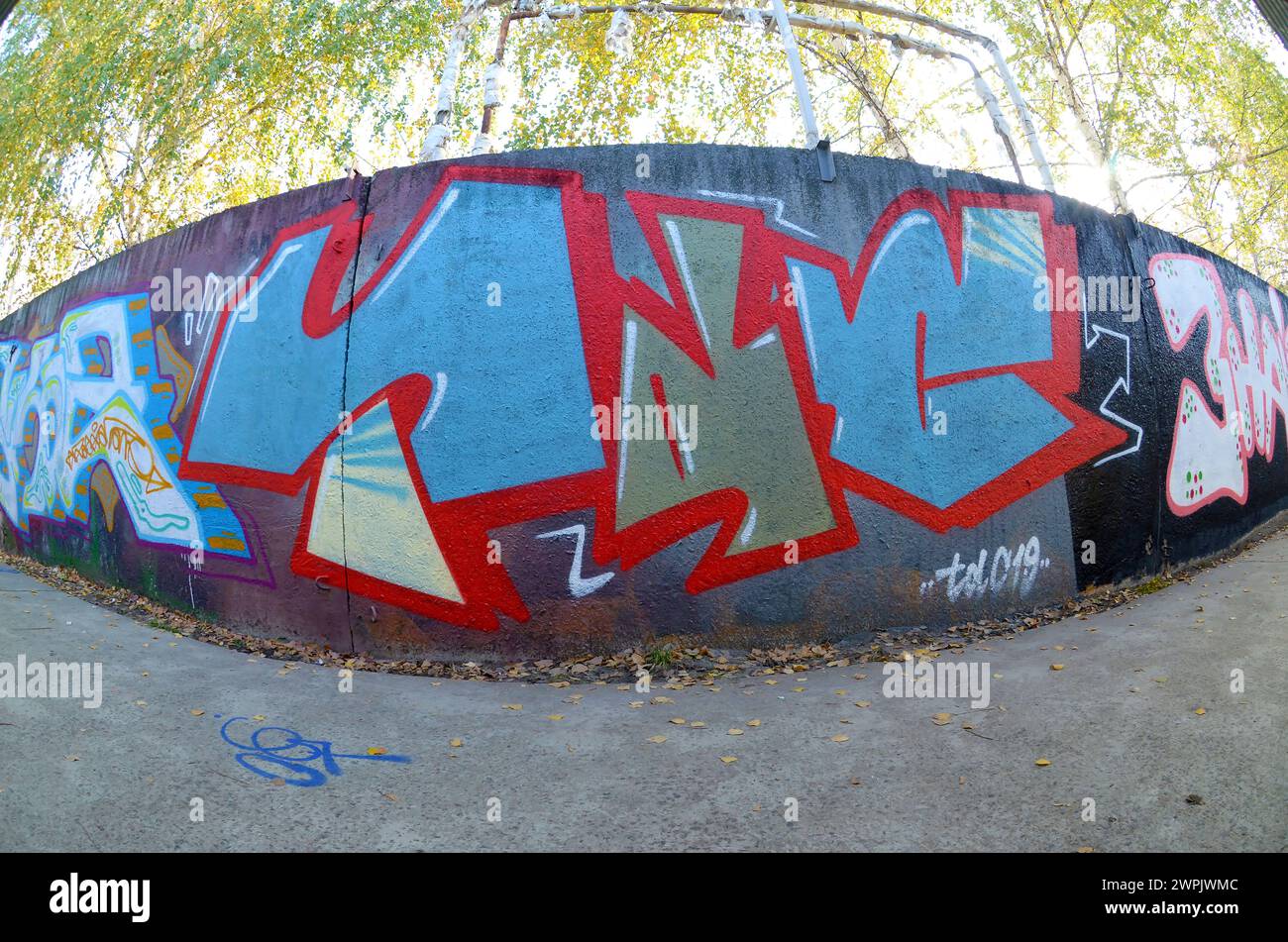 Fisheye shot of street art graffiti drawing on wall. Spray art artwork ...