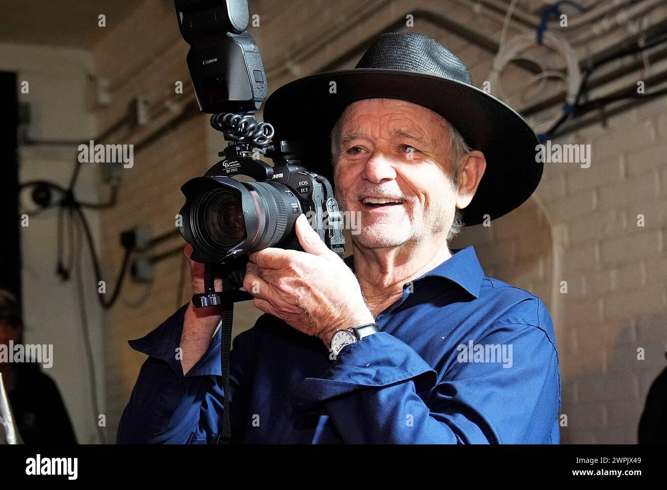 Bill Murray borrows a photographer's camera during arrivals for the 8th ...