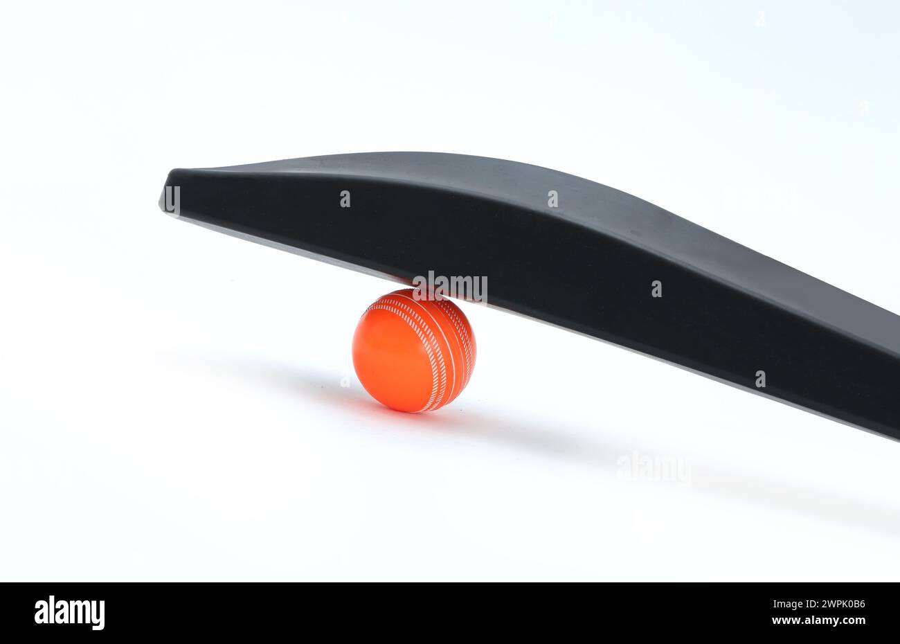 wind ball with black pvc cricket bat isolated Stock Photo - Alamy