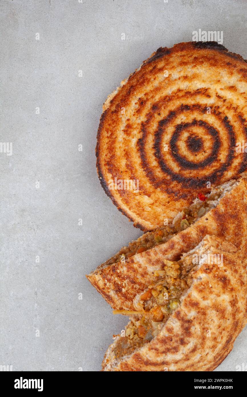 Jaffle, an old school toasted sandwich, filled with savory mince. Grey ...