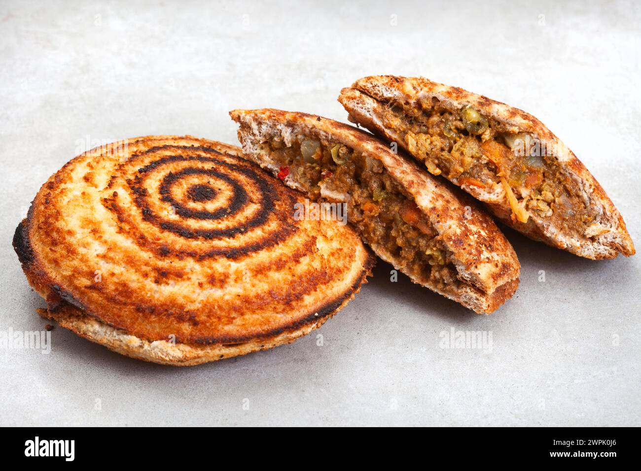 Jaffle, an old school toasted sandwich, filled with savory mince. Grey ...