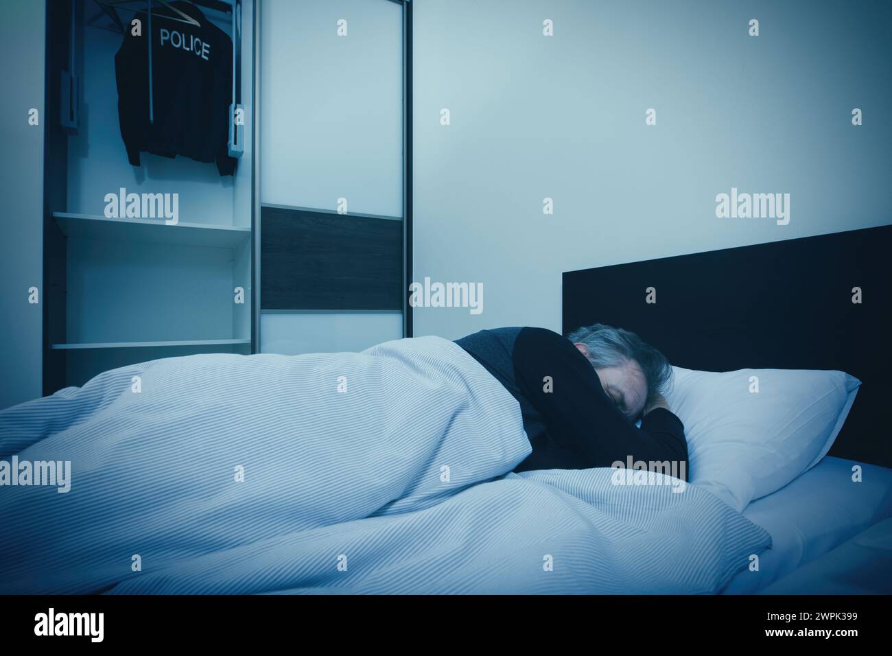 Police officer waking up in his bedroom afraid of intruder Stock Photo ...