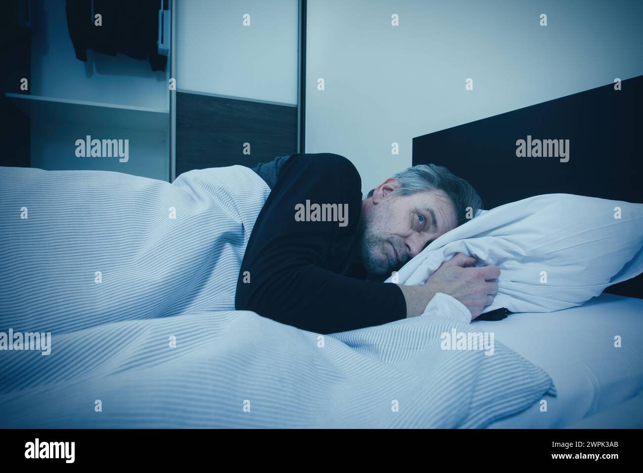 Police officer waking up in his bedroom afraid of intruder Stock Photo ...