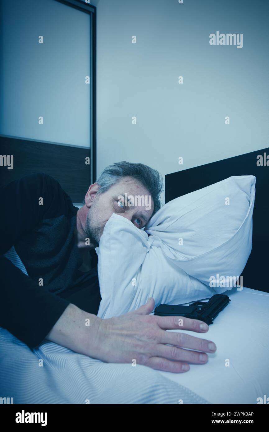 Police officer waking up in his bedroom afraid of intruder Stock Photo ...