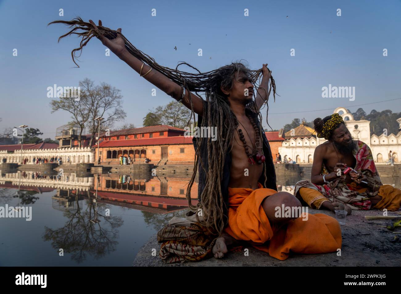 A holy man from India spreads his dreadlocks on the bank of Bagmati ...