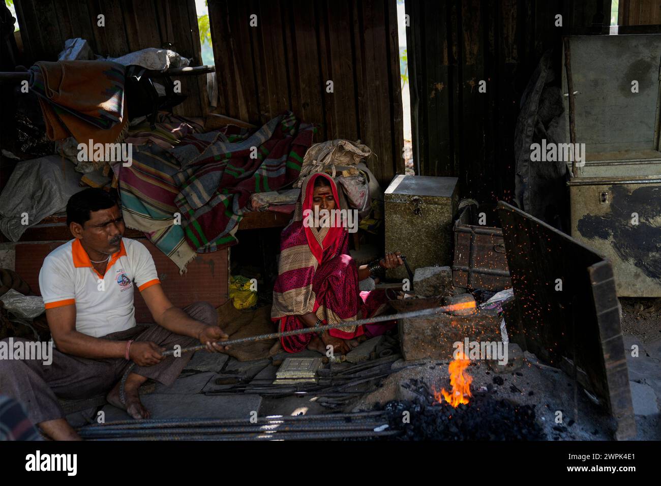 A woman works in a furnace to mould iron on International Women's Day ...